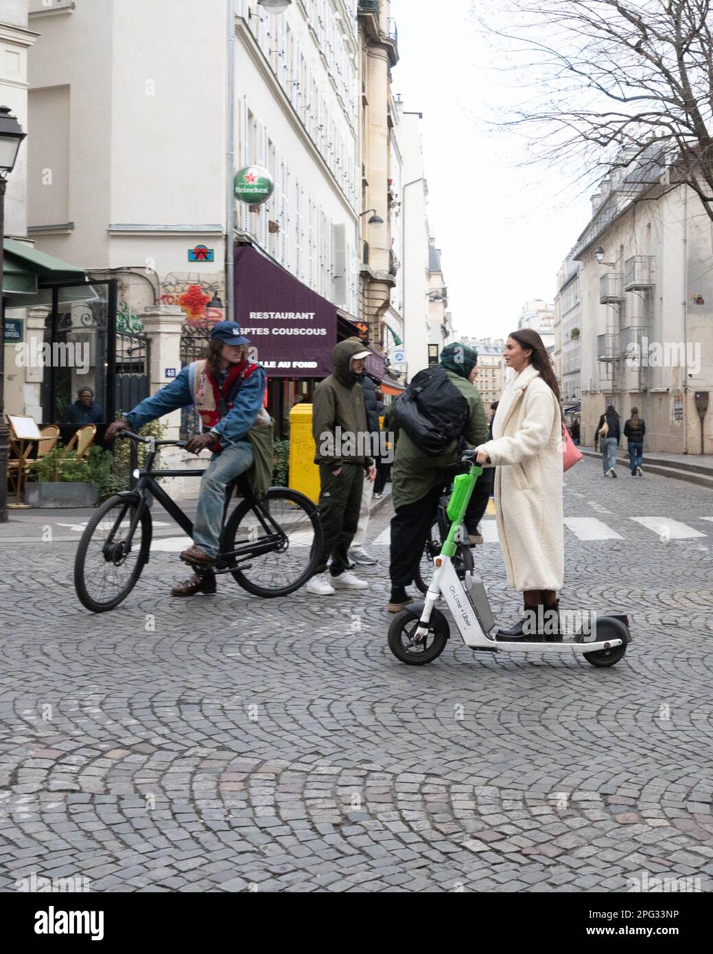 Fashionable beautiful woman on electric scooter scooting through bad ...