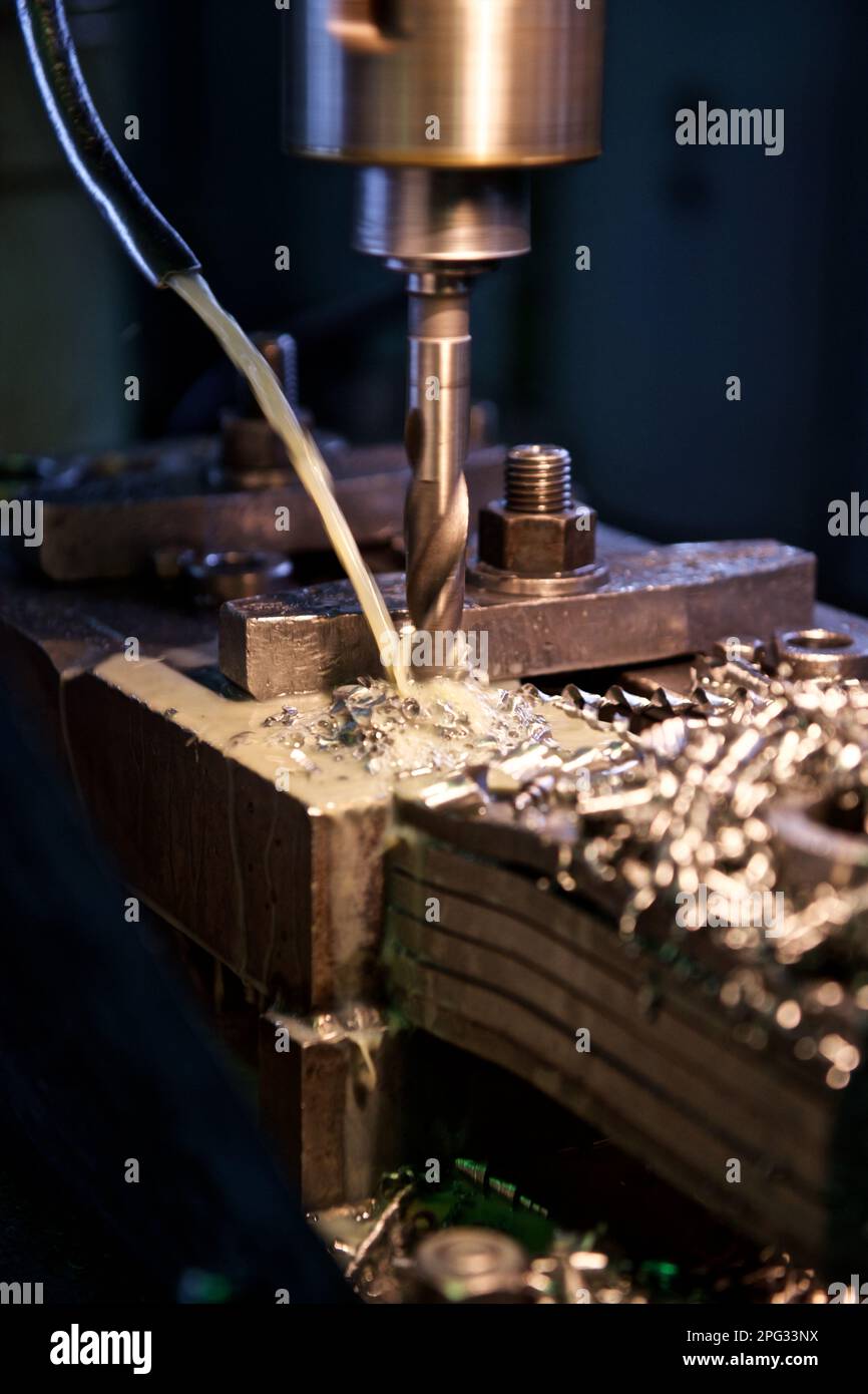 the work of a drill on a metal workpiece at the factory Stock Photo - Alamy