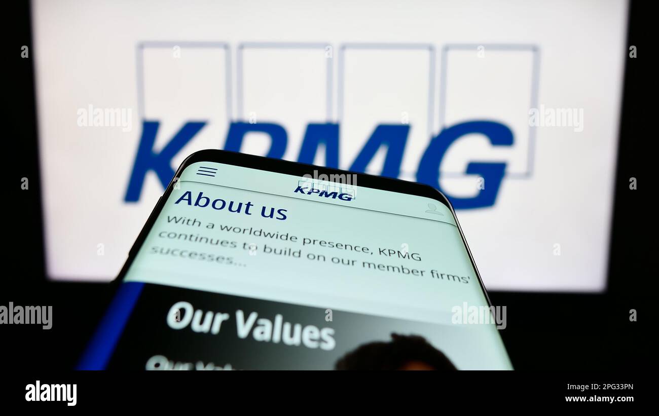 Smartphone with website of professional services company KPMG on screen ...