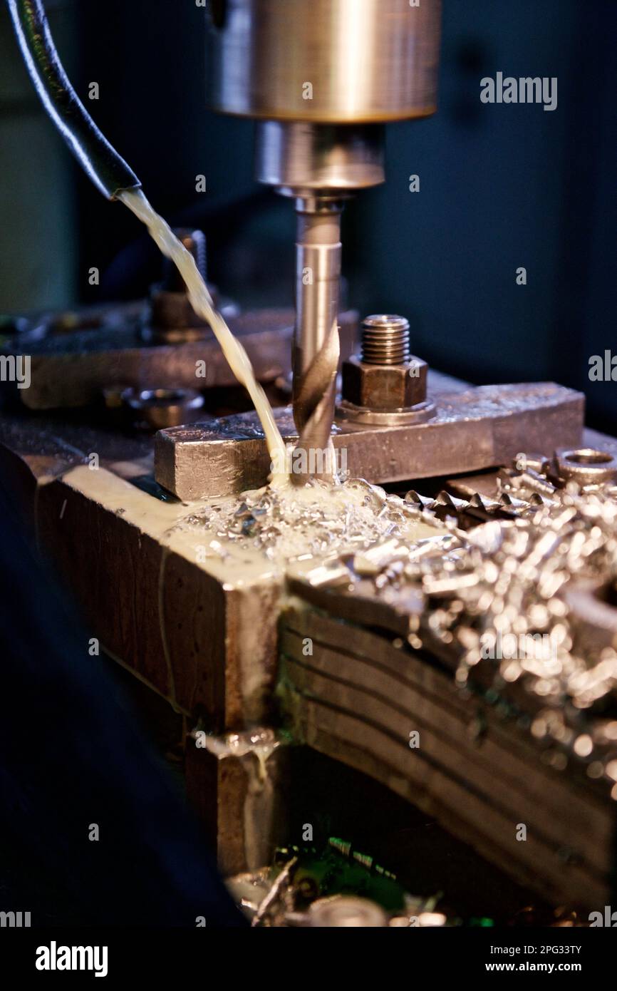 the work of a drill on a metal workpiece at the factory Stock Photo - Alamy