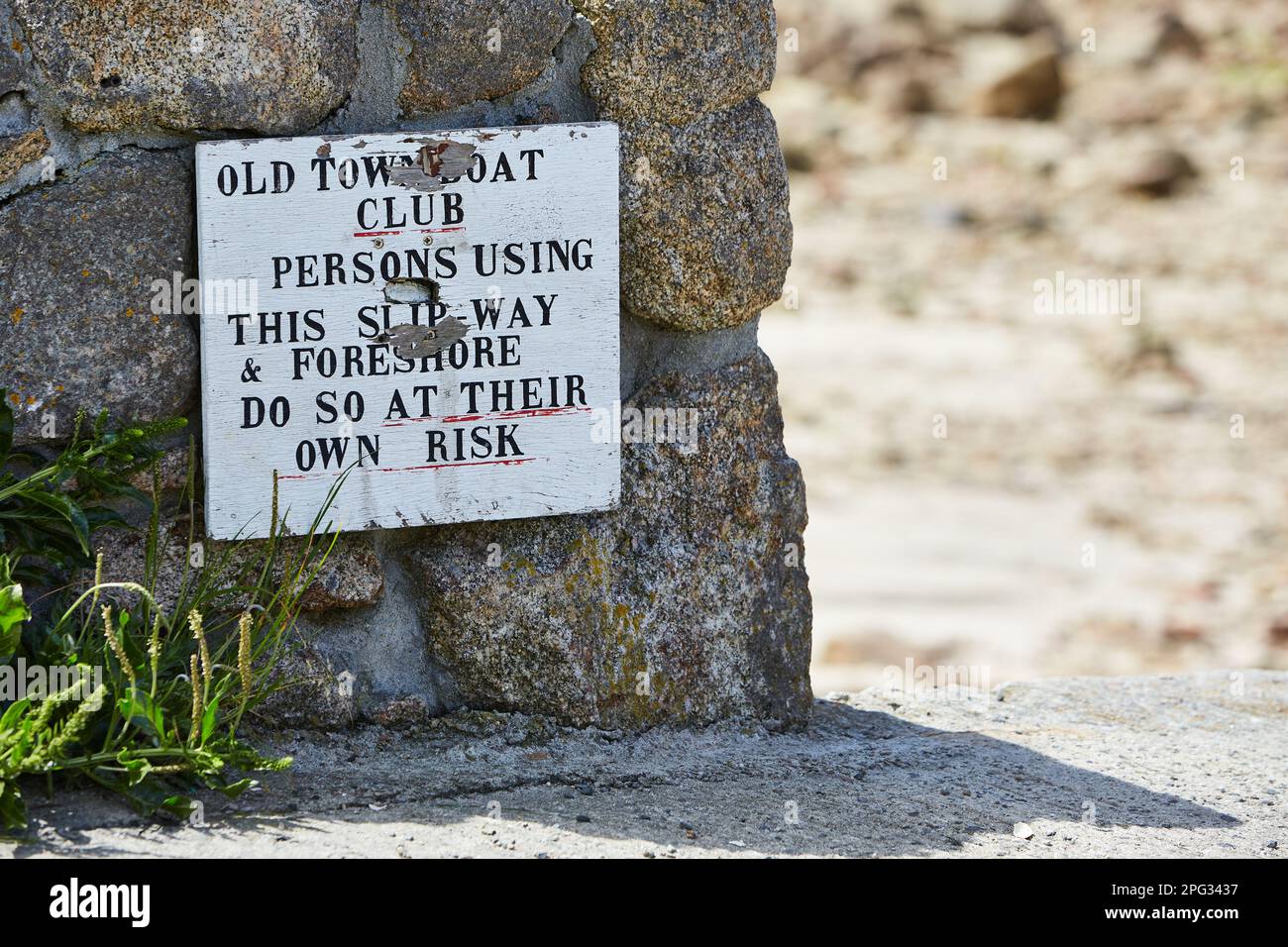 Isles of Scilly, UK - Old handwritten warning sign at a slip-way on St ...