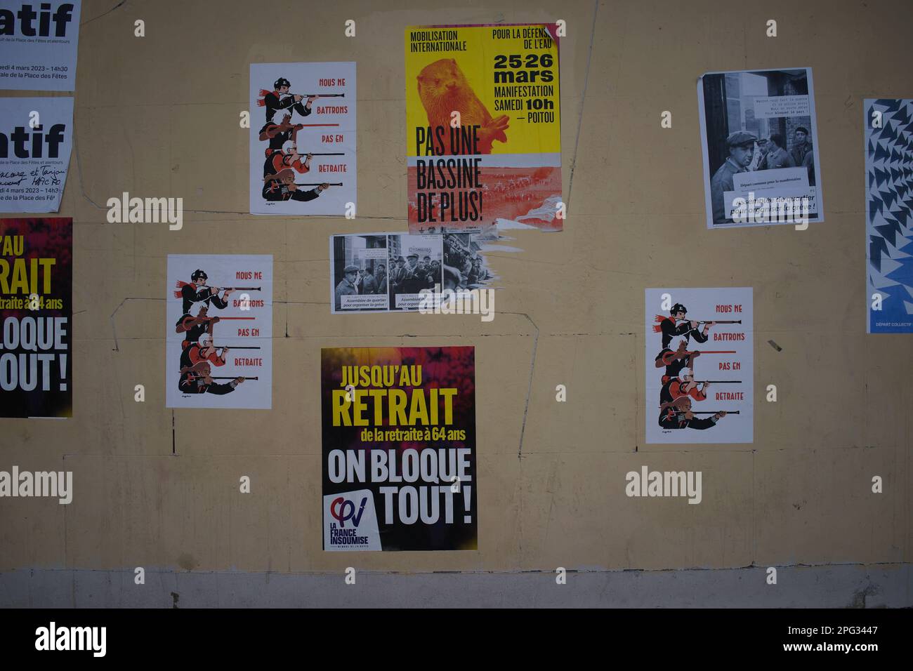 Campaign posters line a wall of Paris' Place des Fetes, as workers ...