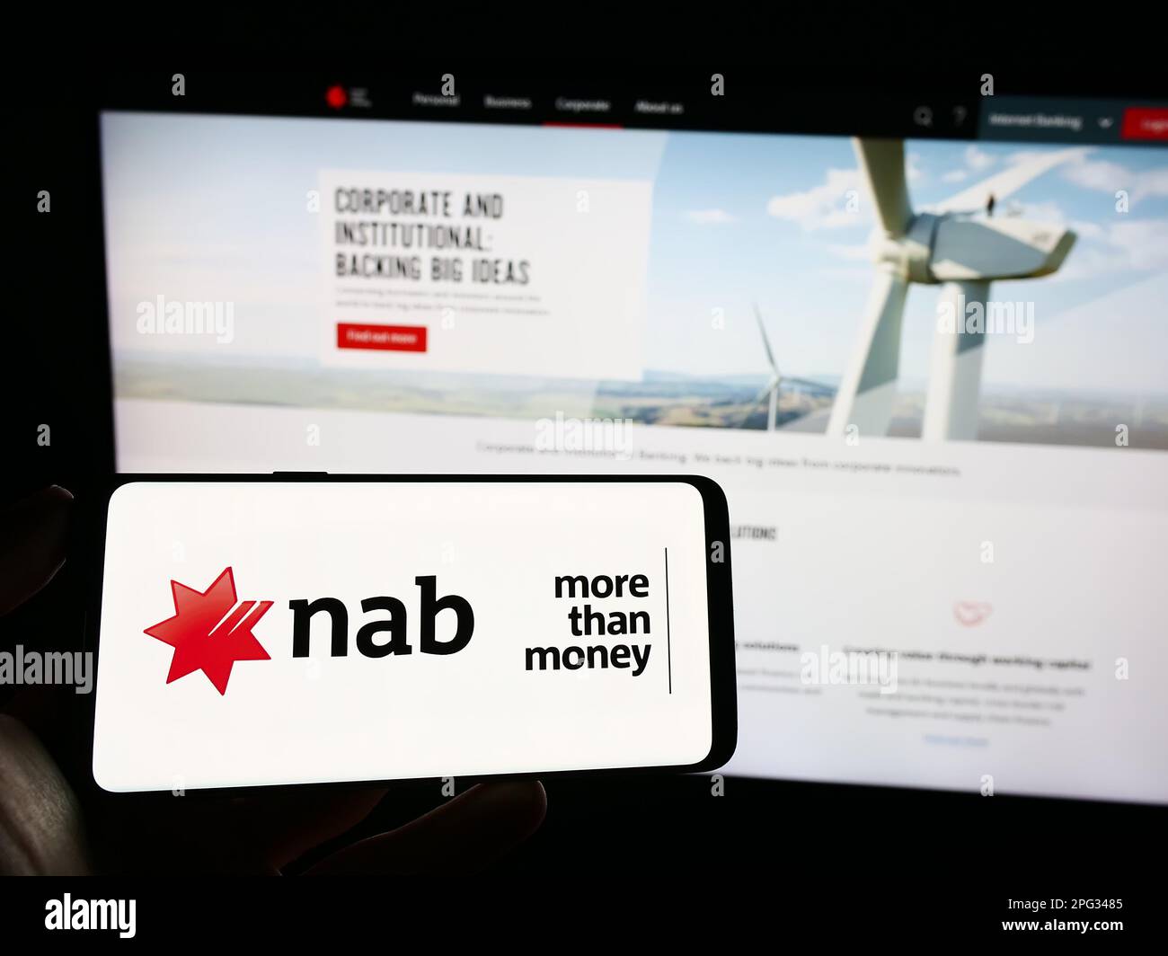 Person holding mobile phone with logo of company National Australia ...