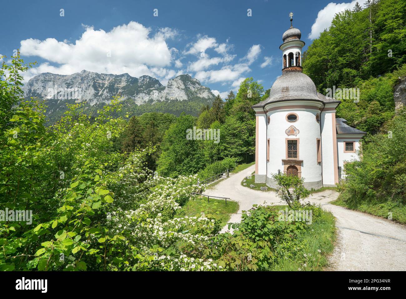 The pilgrimage church of Maria Kunterweg in Ramsau in spring with the mountain range Reiter Alpe ...