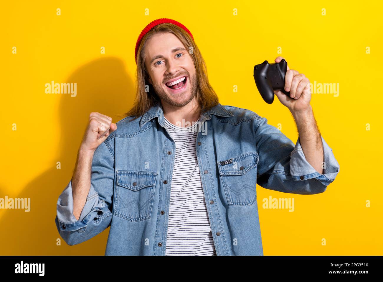 Photo of lucky funky man wear denim jacket rising fist winning ...