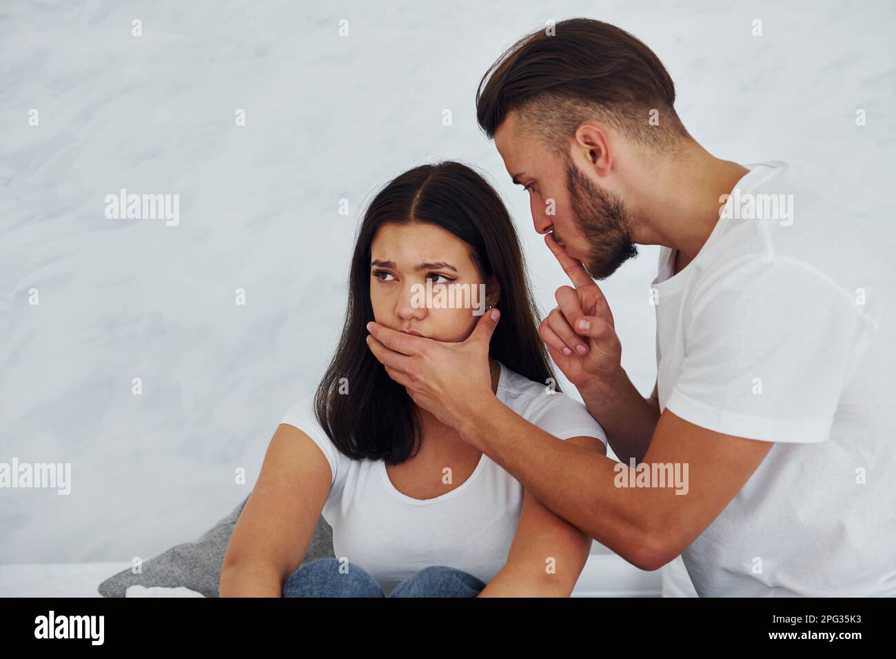 Be quiet. Violent aggressive young man threatening his girlfriend at ...