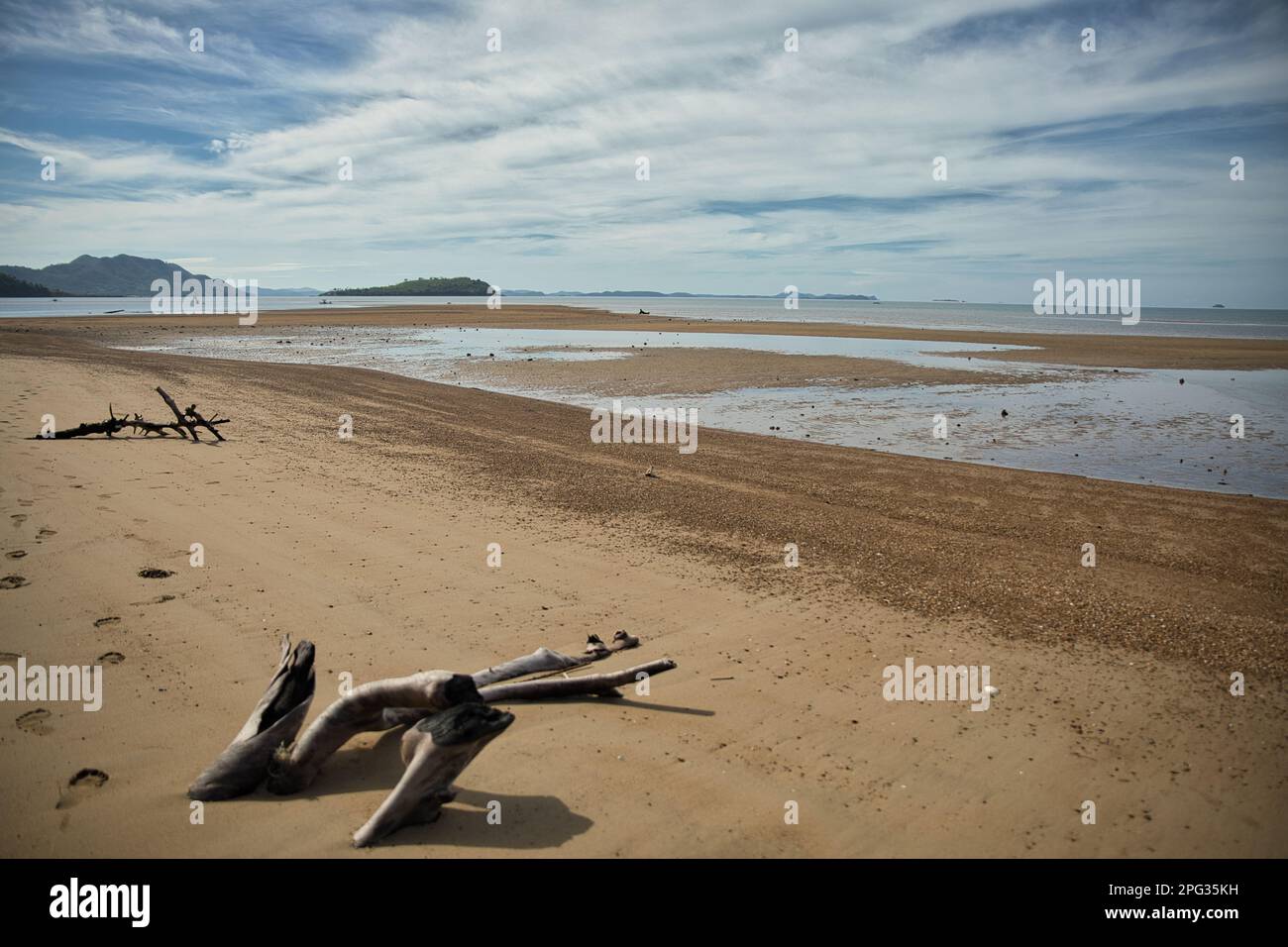 Wide sandy beach in Coron, Philippines, green hills in the background ...
