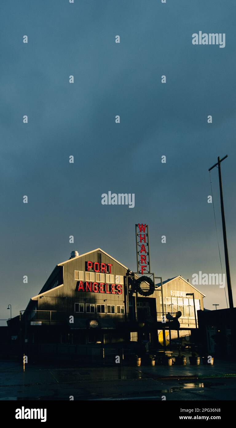 Golden hour sunrise rays beaming off the Port Angeles Wharf building ...