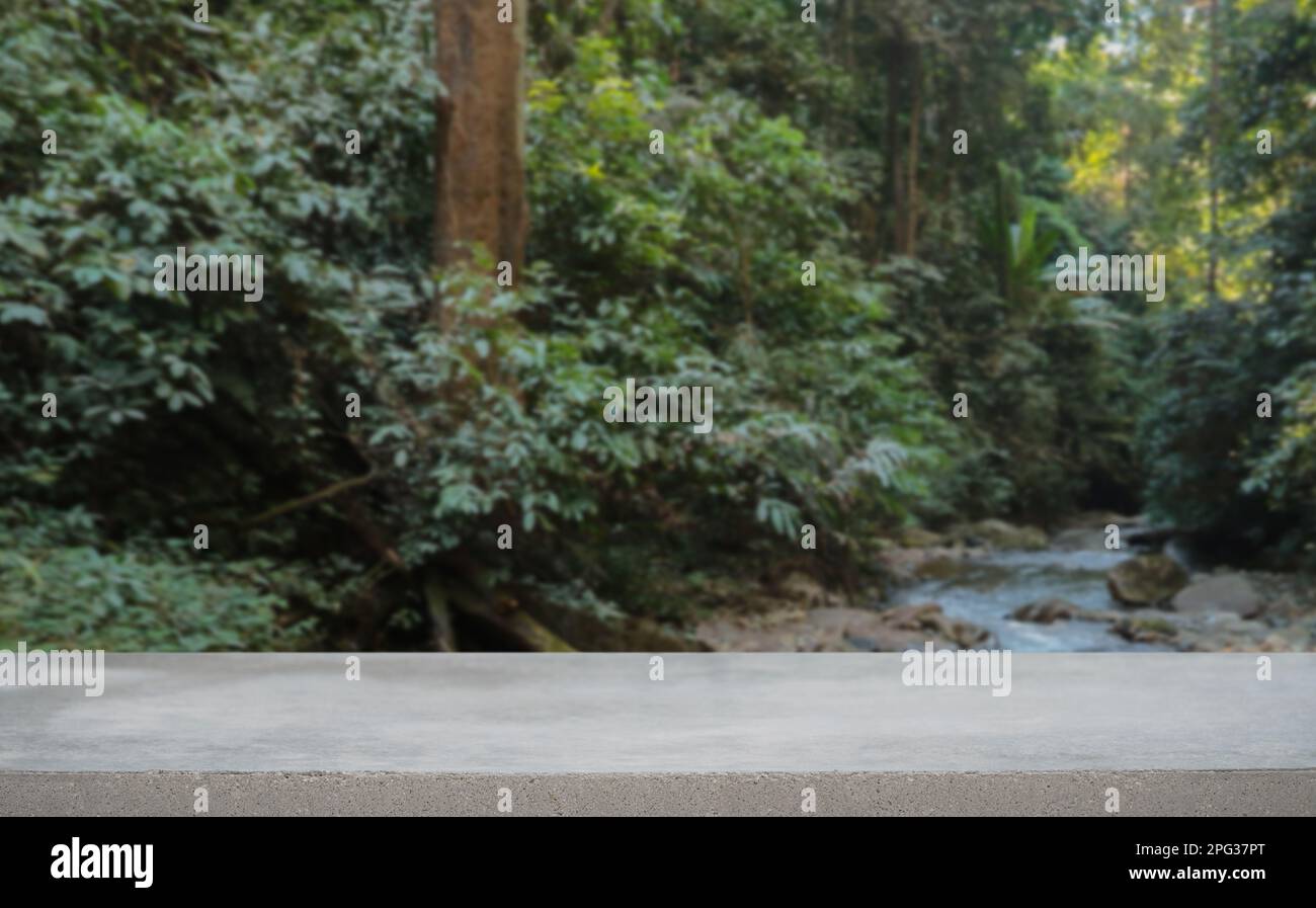 Concrete tabletop podium floor on outdoors blurred tropical forest ...