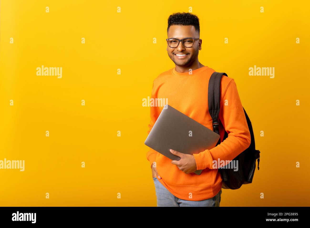Happy excited foreign male student with backpack standing isolated on ...
