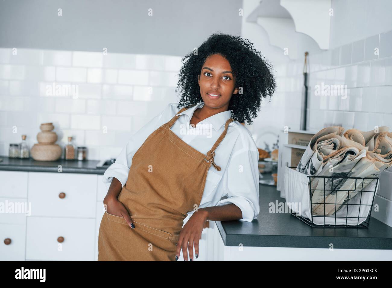 On the kitchen. Young african american woman with curly hair indoors at ...