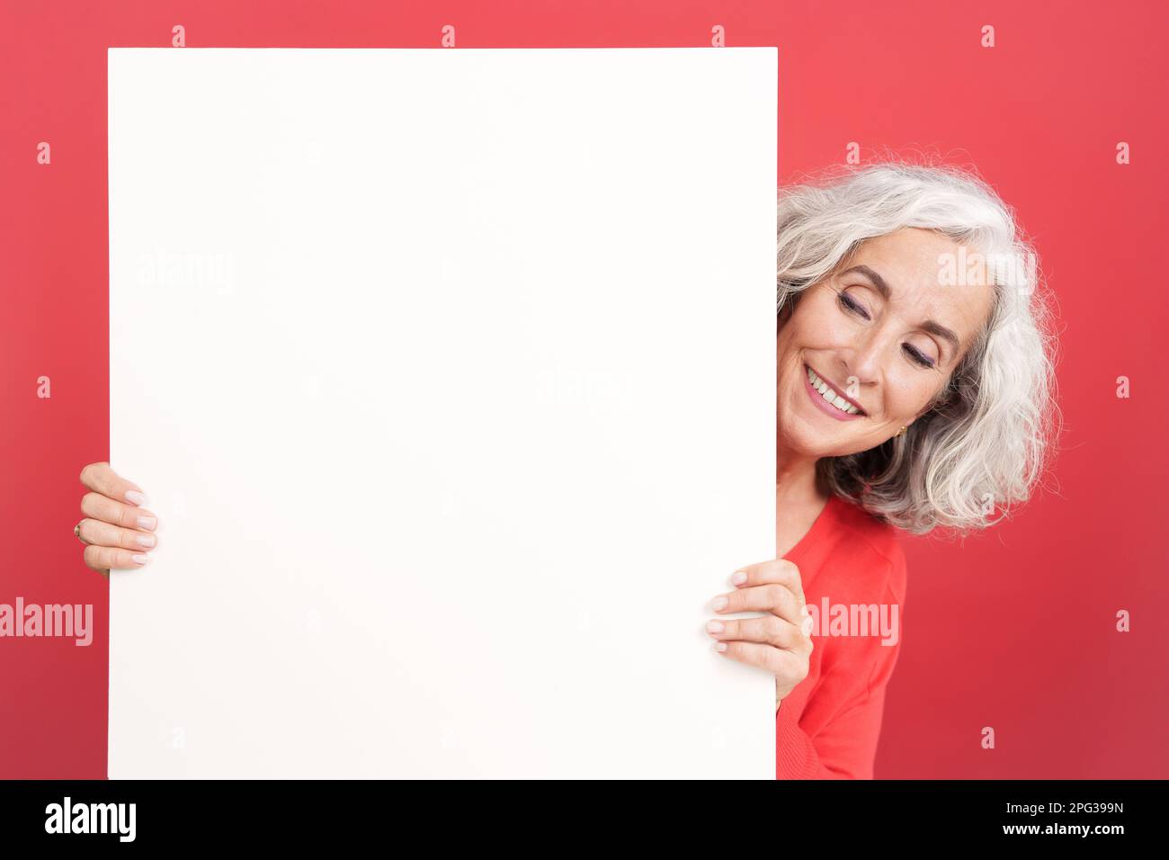 Woman looking at the white board that she is holding Stock Photo - Alamy