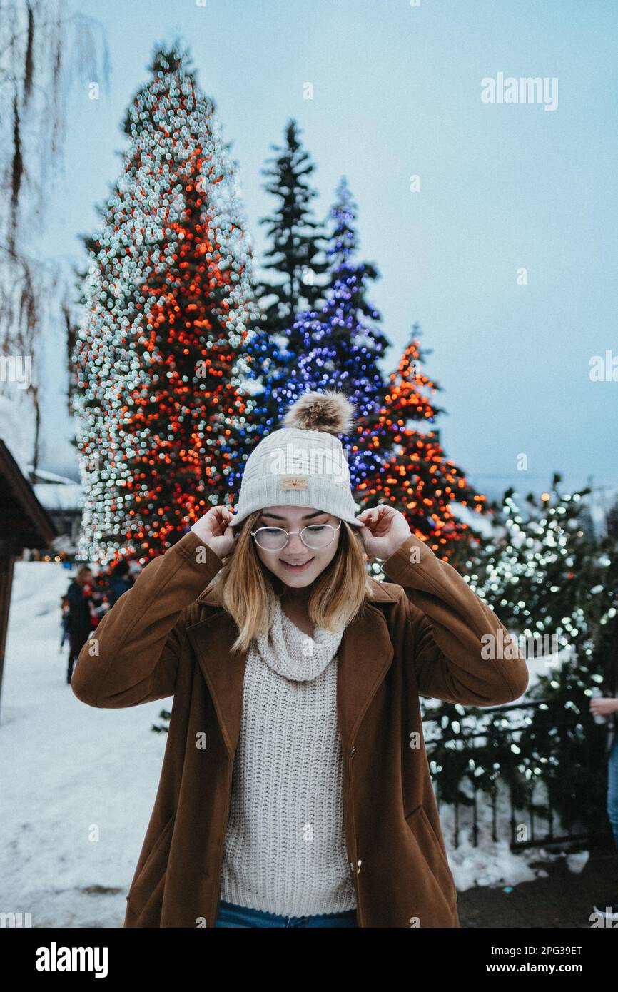 Girl looking down amidst the snow Stock Photo - Alamy