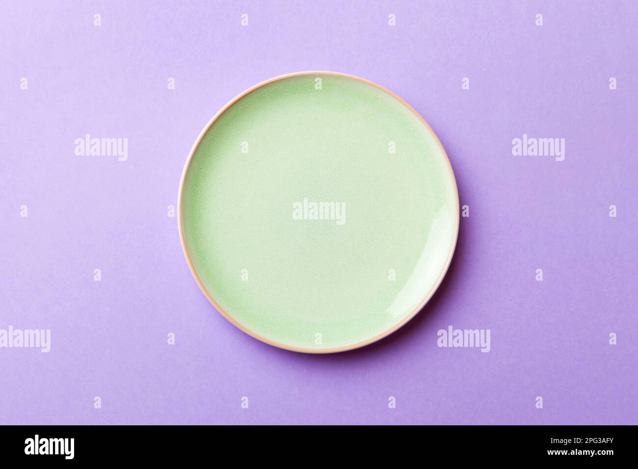 Top view of isolated of colored background empty round green plate for ...