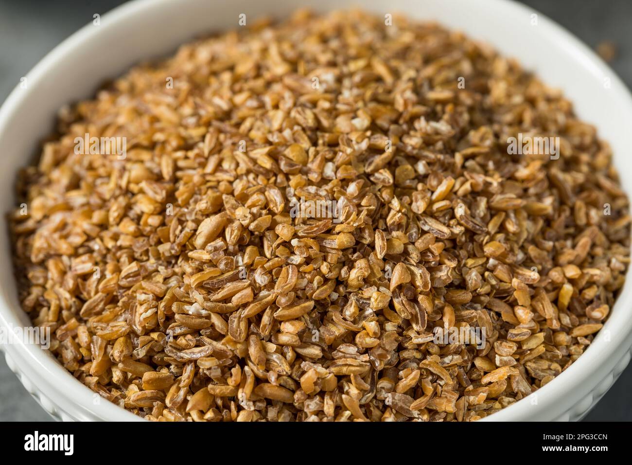 Raw Brown Organic Bulgar Wheat in a Bowl Stock Photo - Alamy