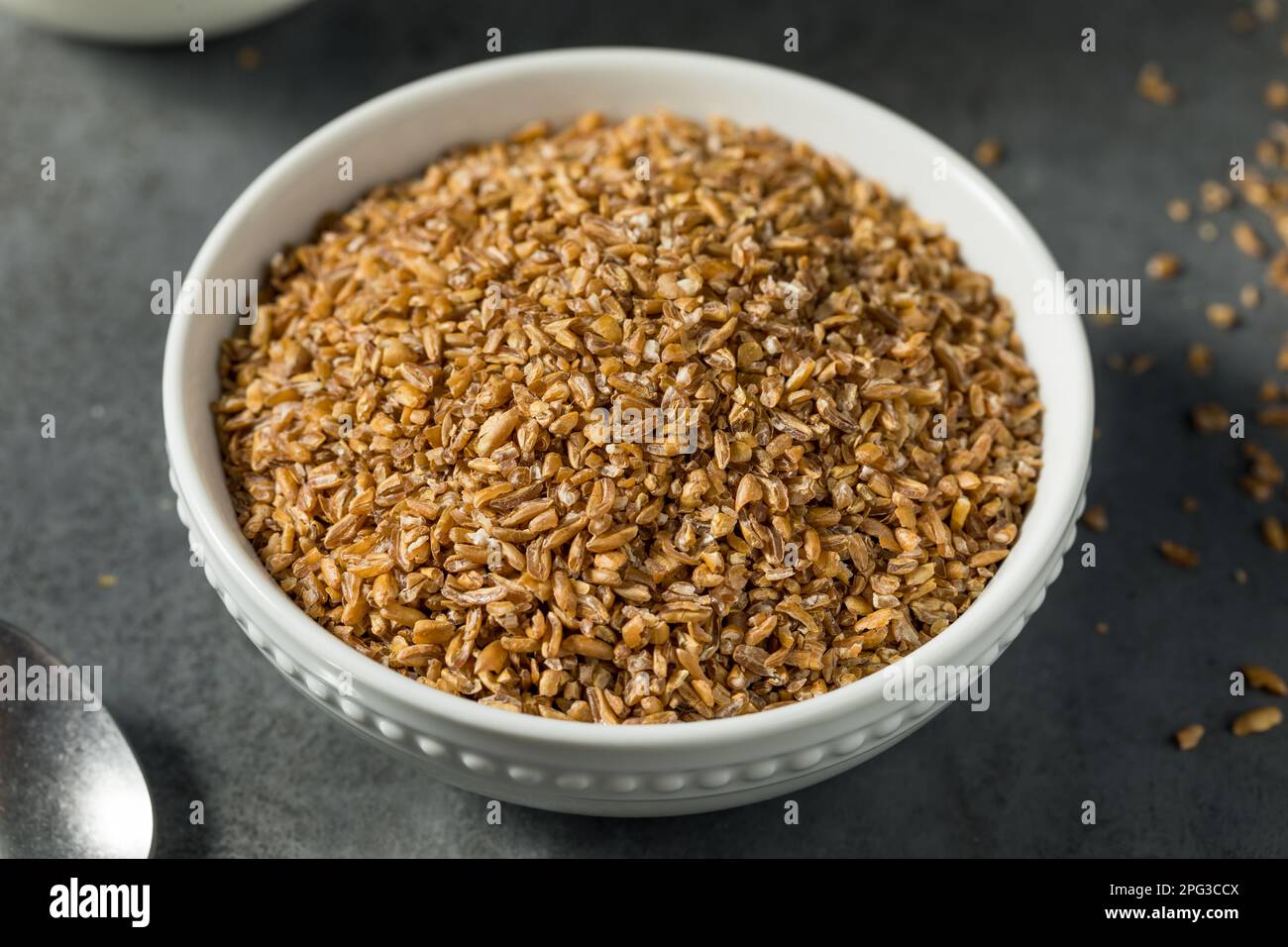 Raw Brown Organic Bulgar Wheat in a Bowl Stock Photo - Alamy
