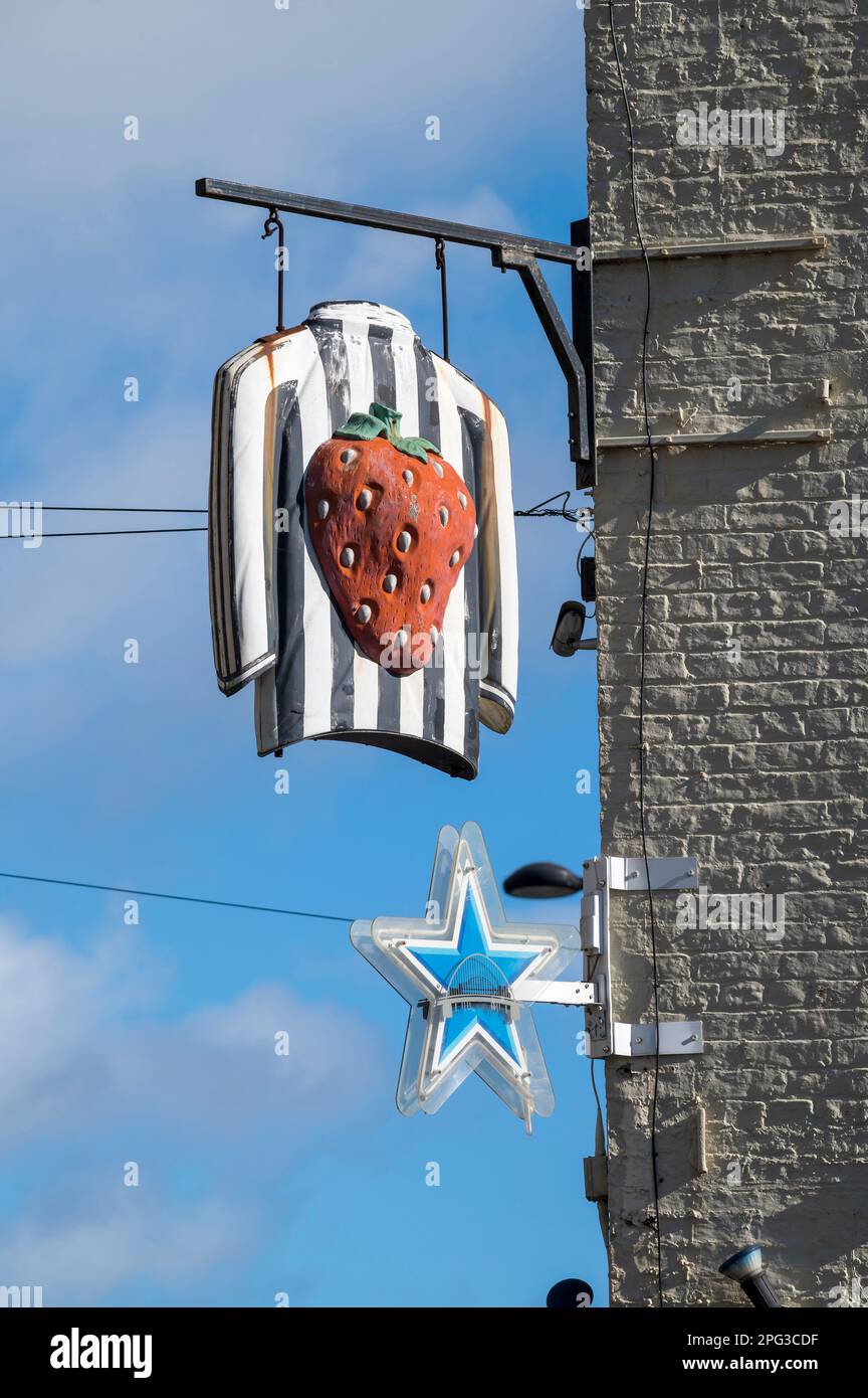Sign hanging outside The Strawberry public house near St. James' Park ...