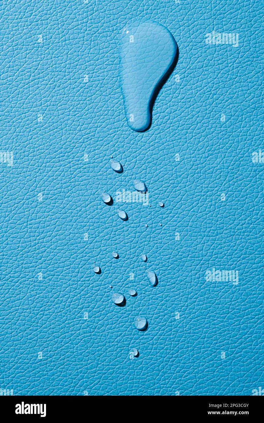 high angle view of a large drop of water and some other smaller drops ...