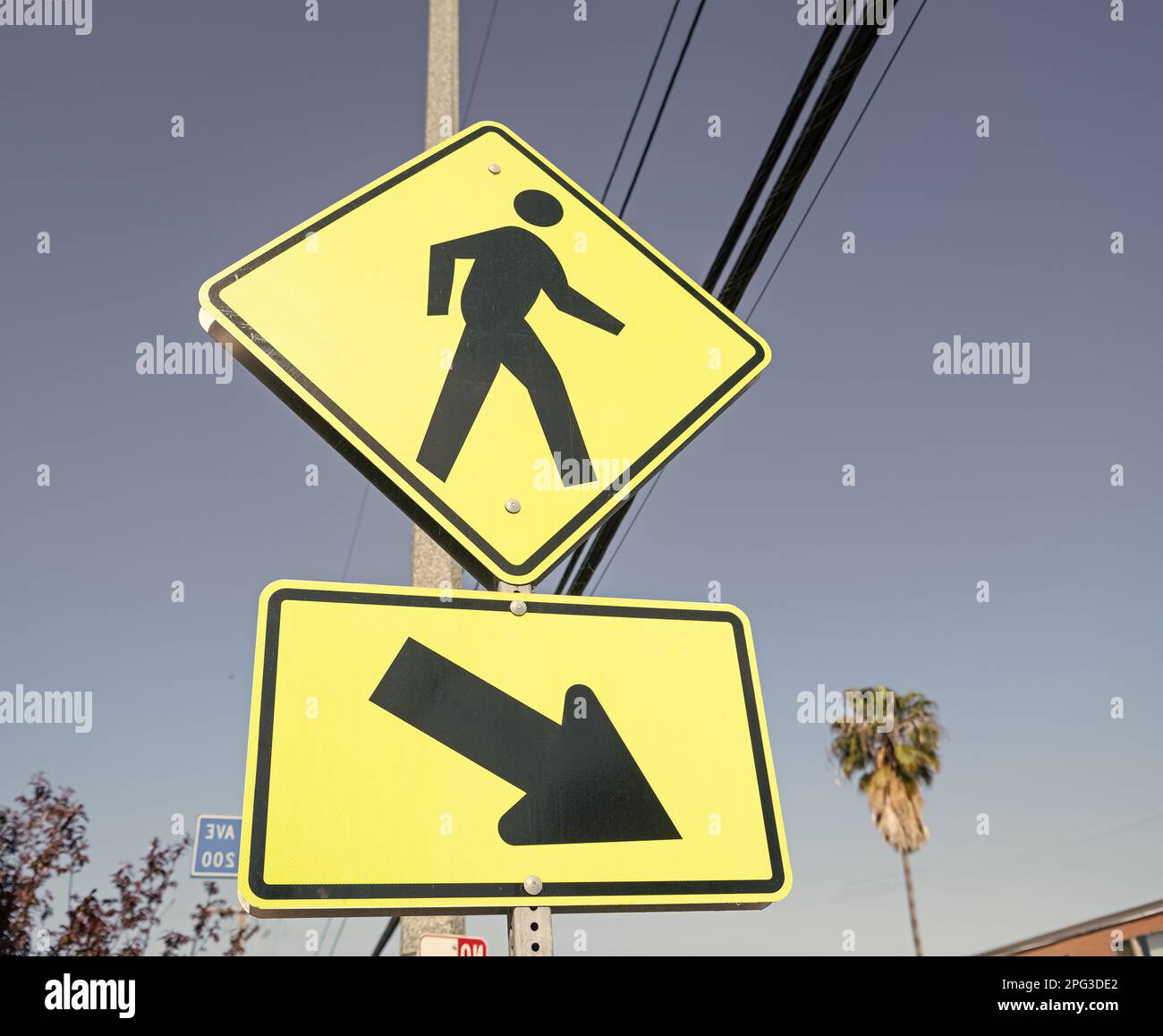 yellow road sign for pedestrian directing this way Stock Photo - Alamy