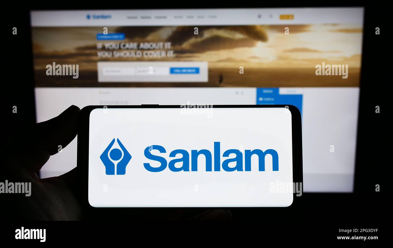 Person holding smartphone with logo of South African financial company ...