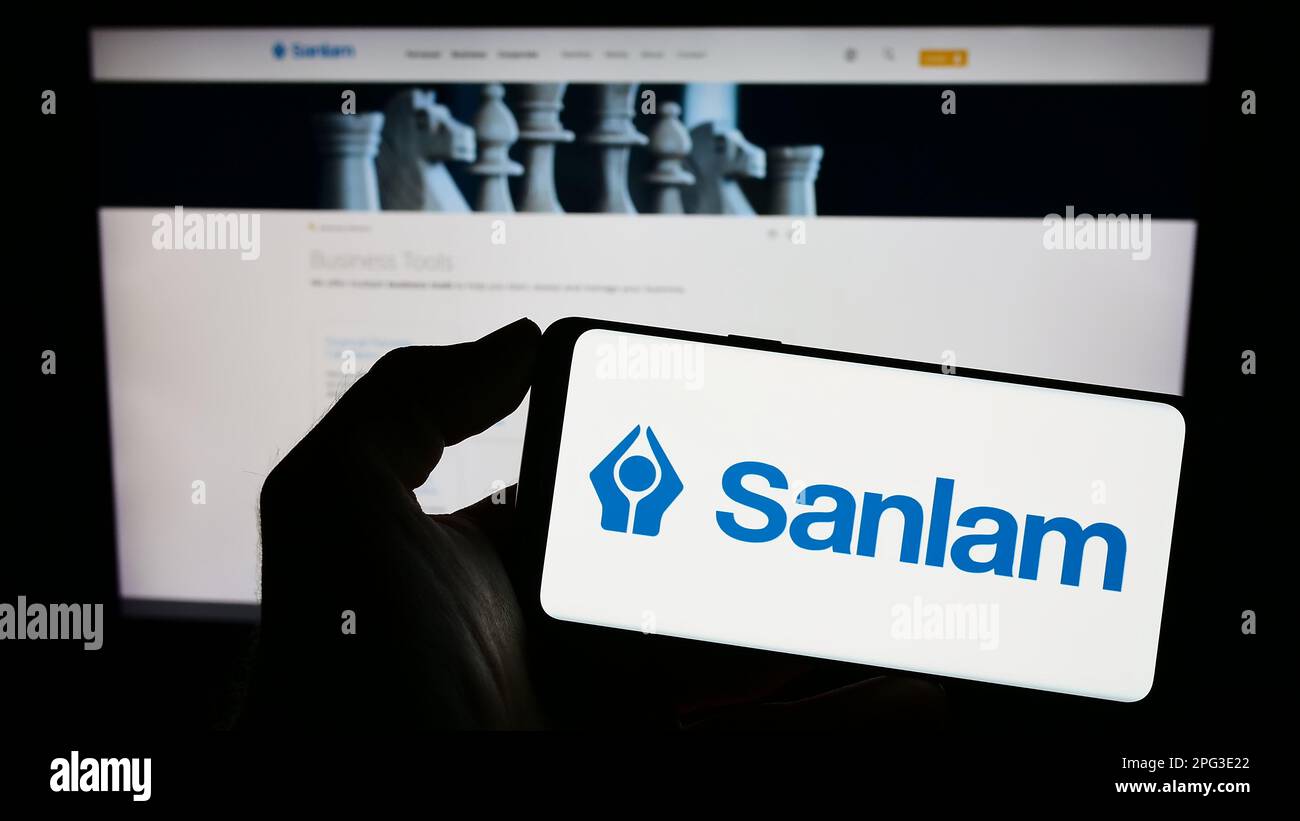 Person holding cellphone with logo of South African financial company Sanlam Limited on screen ...