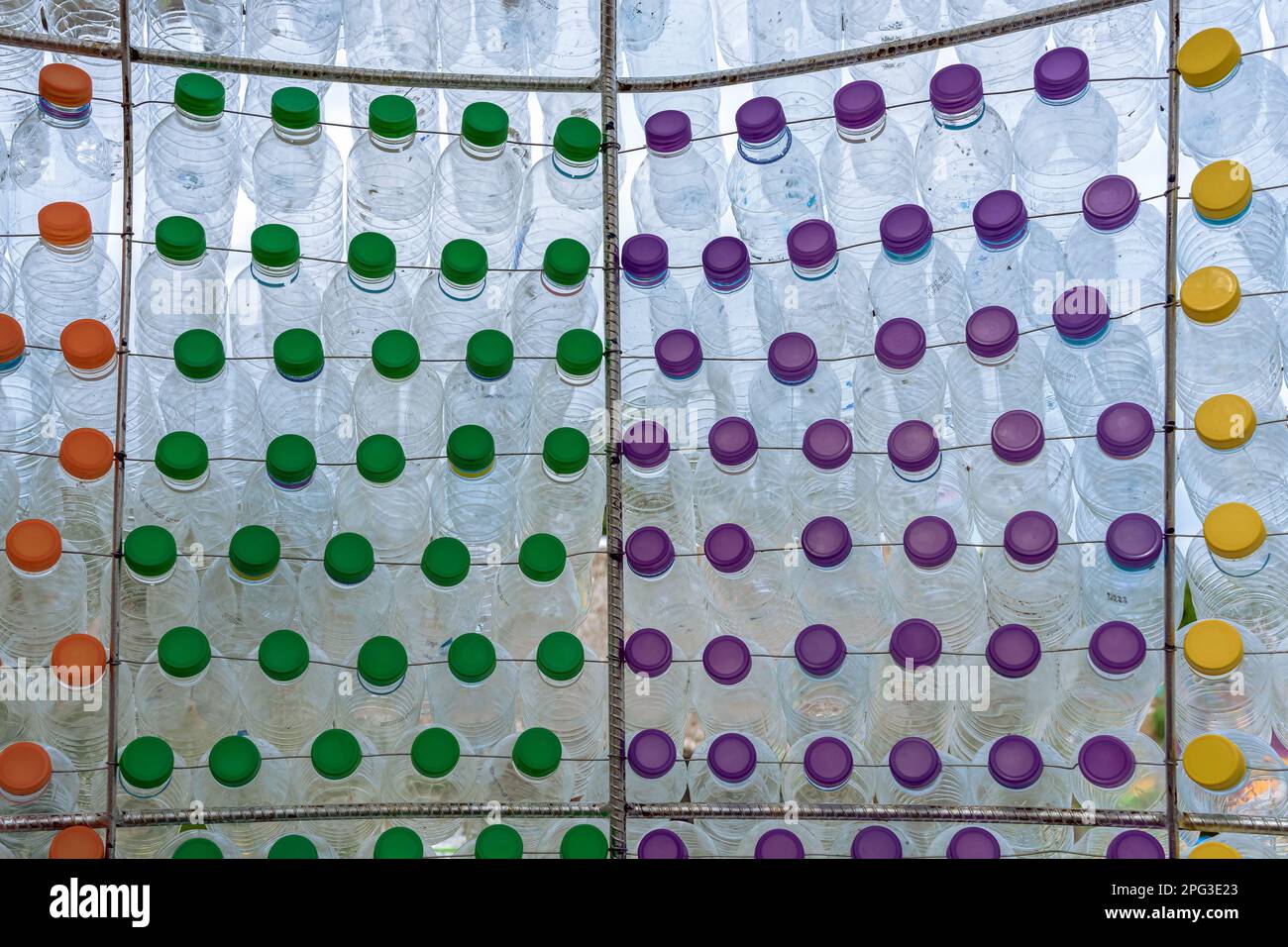 Beautiful wall made of multi colored recycled plastic bottles. Bottle ...