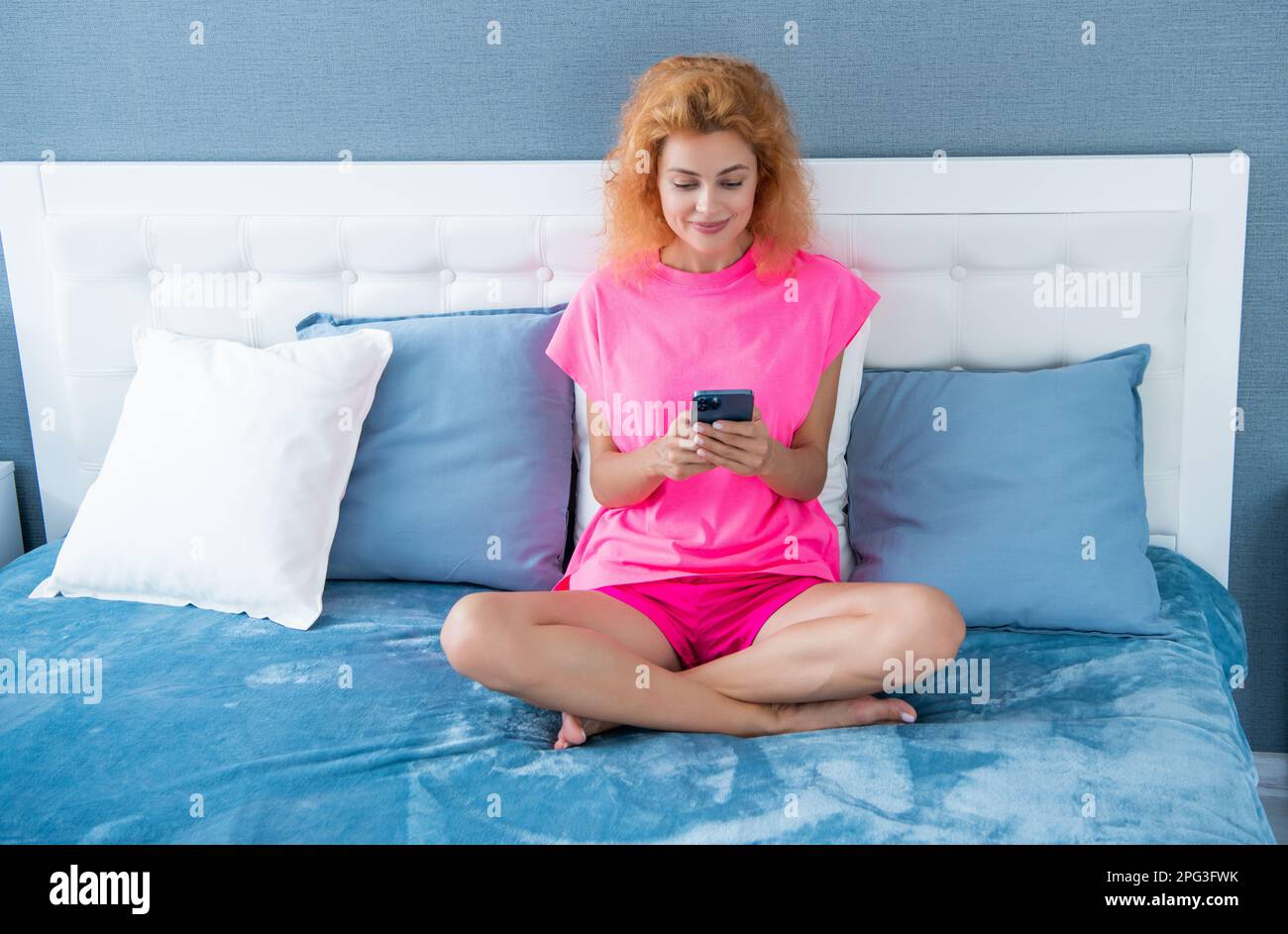 cheerful girl at home has communication on phone. girl using phone ...