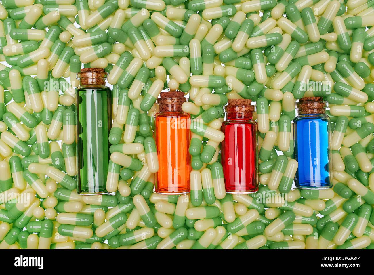 Four color semi-transparent bottles with capsules around they Stock ...
