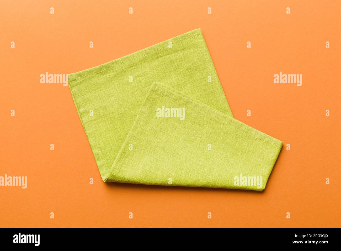 top view with green kitchen napkin isolated on table background. Folded ...