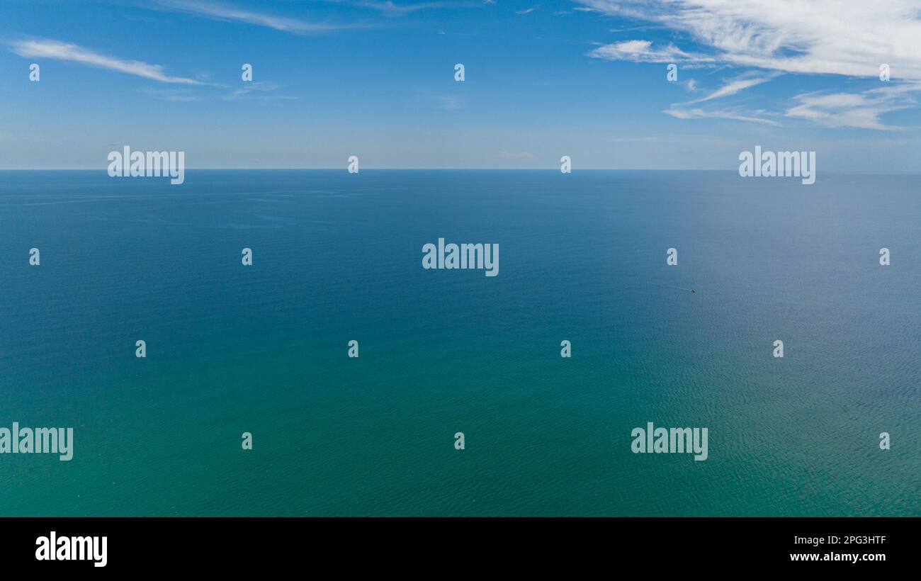 Aerial view of blue ocean with waves and blue skies with clouds ...