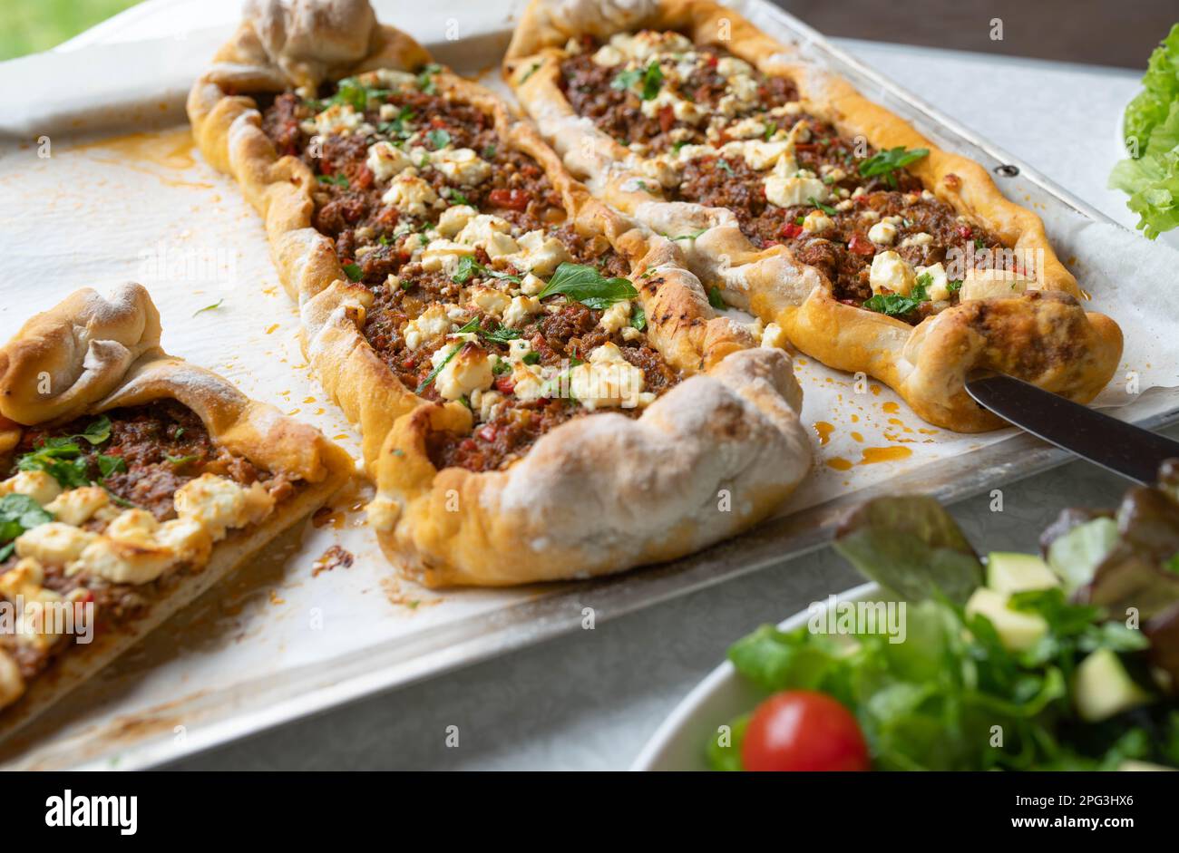 Homemade turkish pide with ground beef, vegetables and feta cheese ...