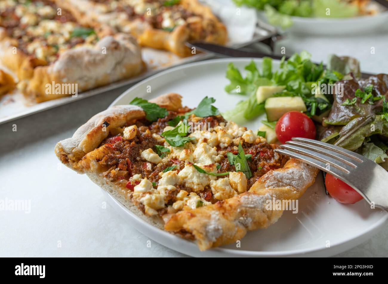 Turkish pide with mince meat, vegetable, feta cheese topping Stock ...
