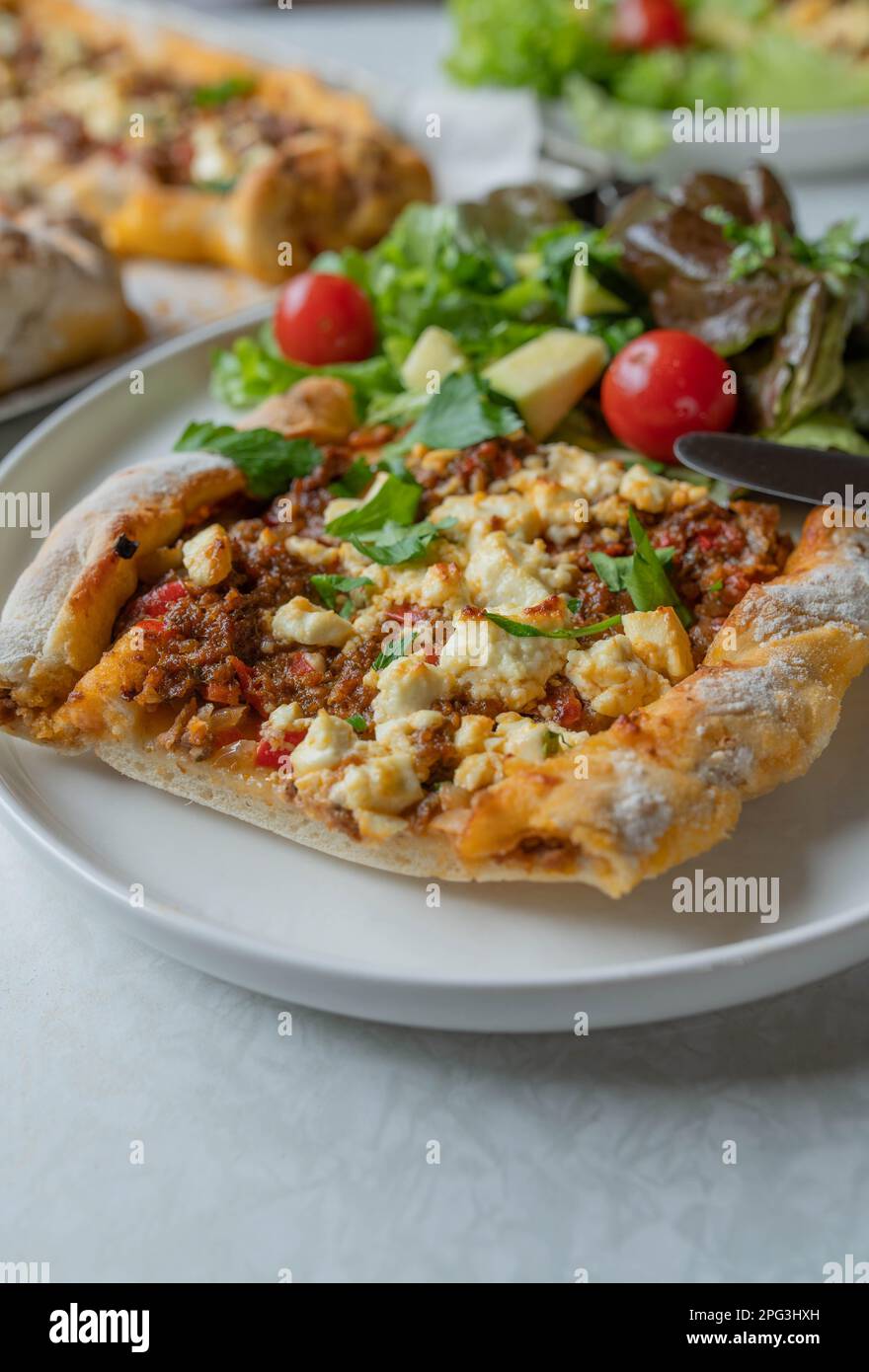 Turkish pide with mince meat, vegetable, feta cheese topping Stock ...