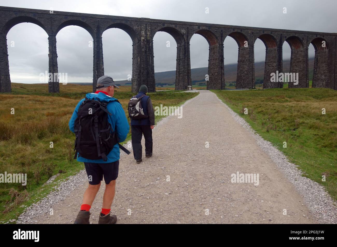 Two Men (Hikers) Walking on a Track to the Stone Ribblehead Railway ...