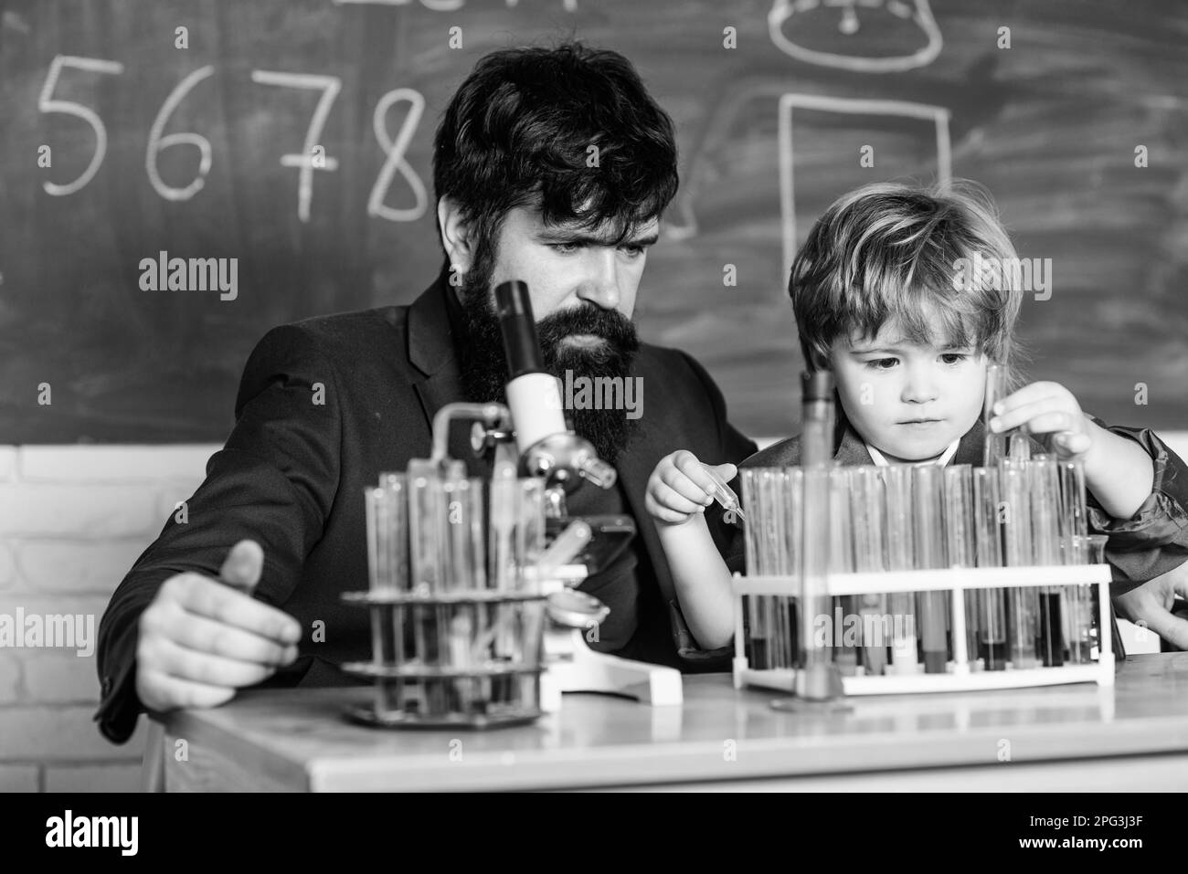 Knowledge day. Genius minds. Teacher bearded man father and child test ...