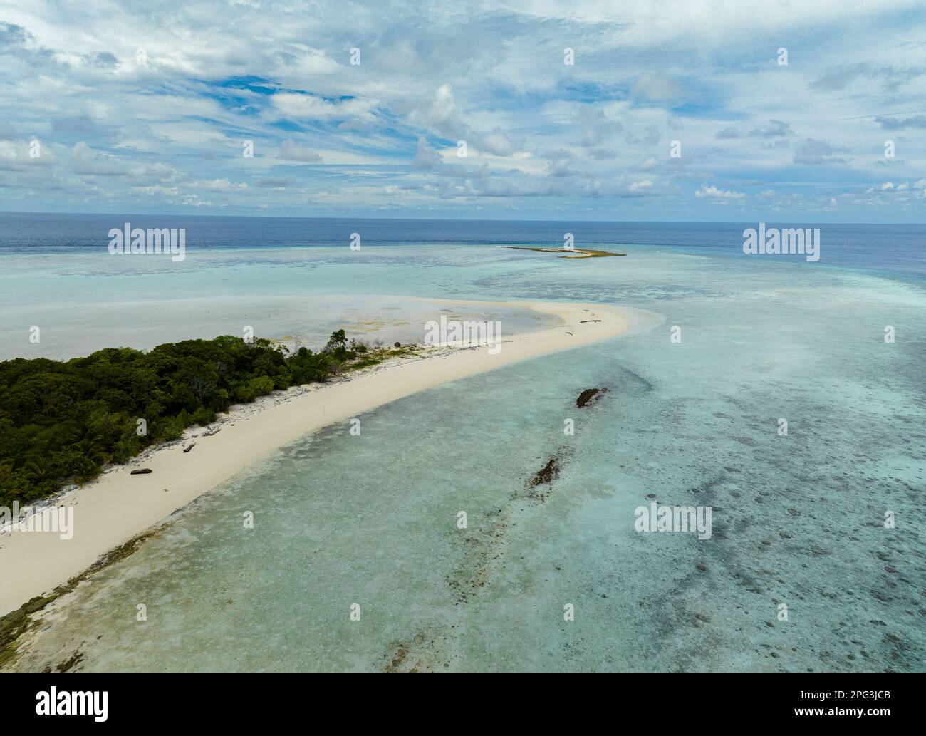 Aerial drone of island with beach and coral reef in the tropics. Pom ...