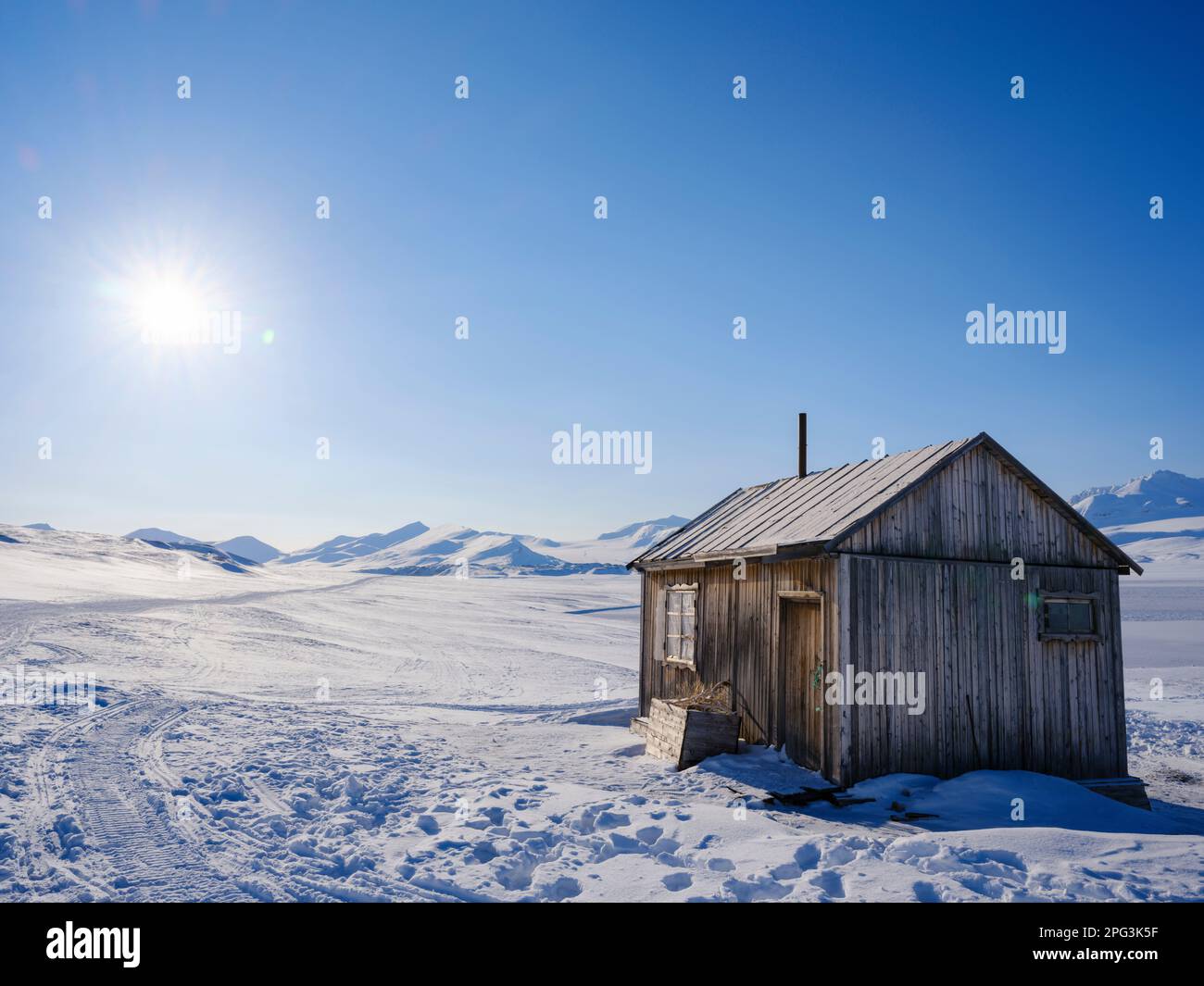 Traditional hut at frozen Groenfjorden, Island of Spitsbergen, part of ...