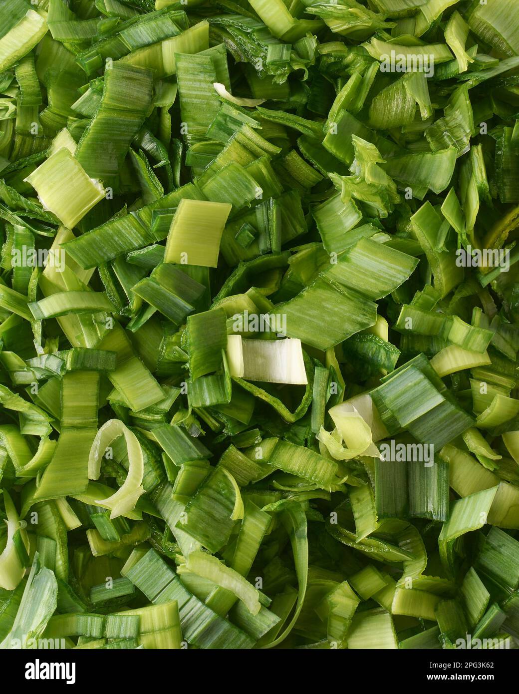 close-up of chopped leek leaves, edible lighter green leafy vegetable ...