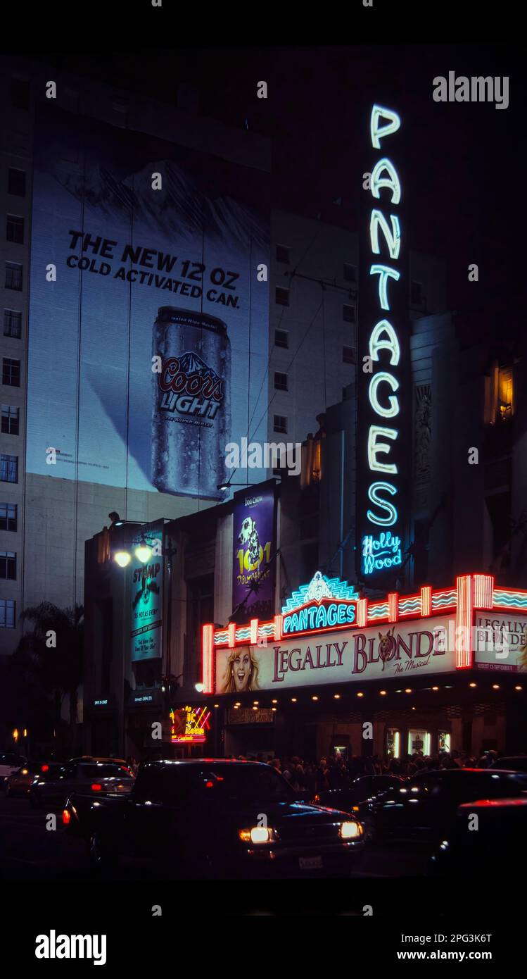 Night view of the Pantages theater, lit up with neon lights, with a ...