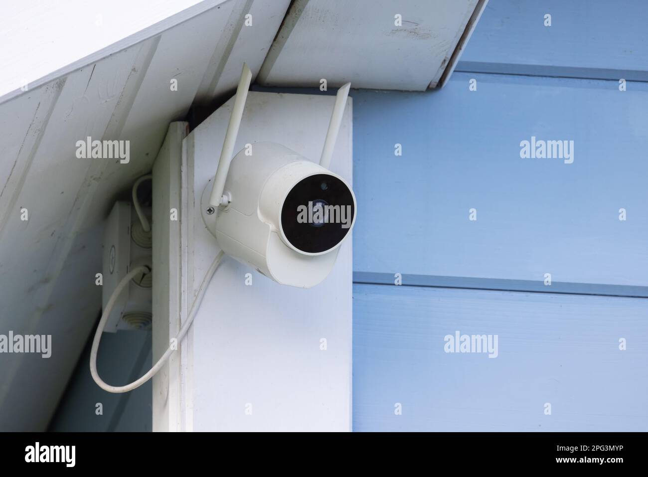 An outdoor surveillance camera with motion detector and Wi-Fi antennas ...