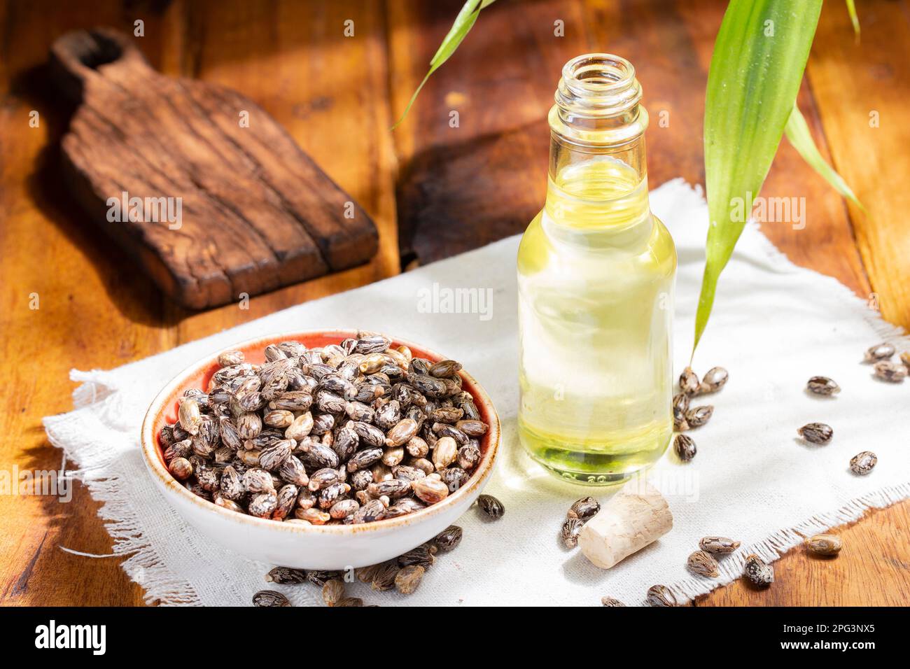 castor seeds and oil, on wooden surface, royalty free Stock Photo - Alamy