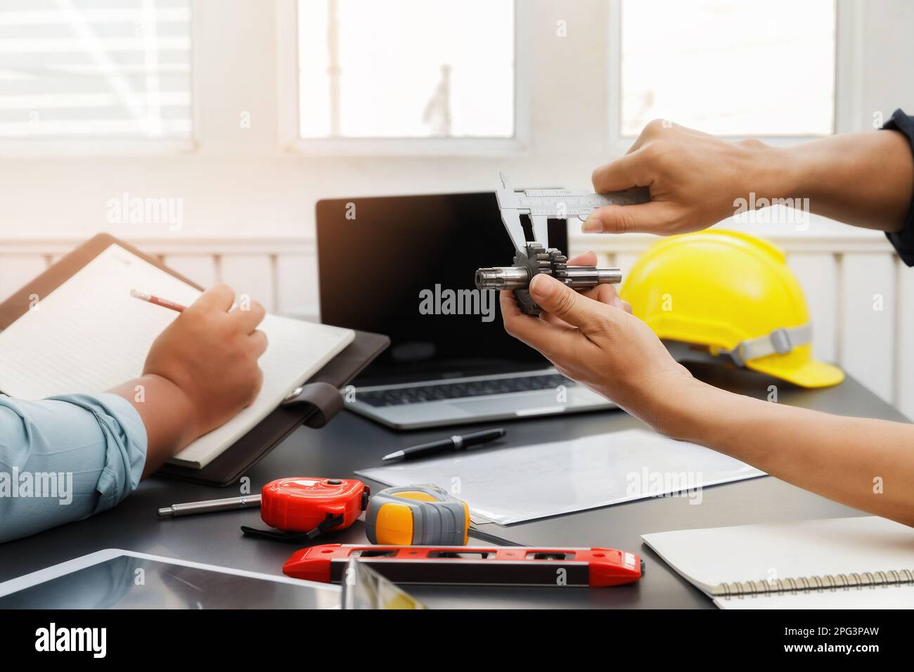 The engineering team is working on their project together. Man work ...