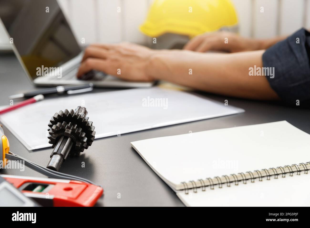 Close Up mechanical gear parts on office desk with engineers working ...