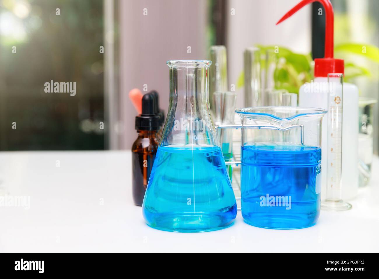Blue experiment water in beaker and flask in chemistry science ...