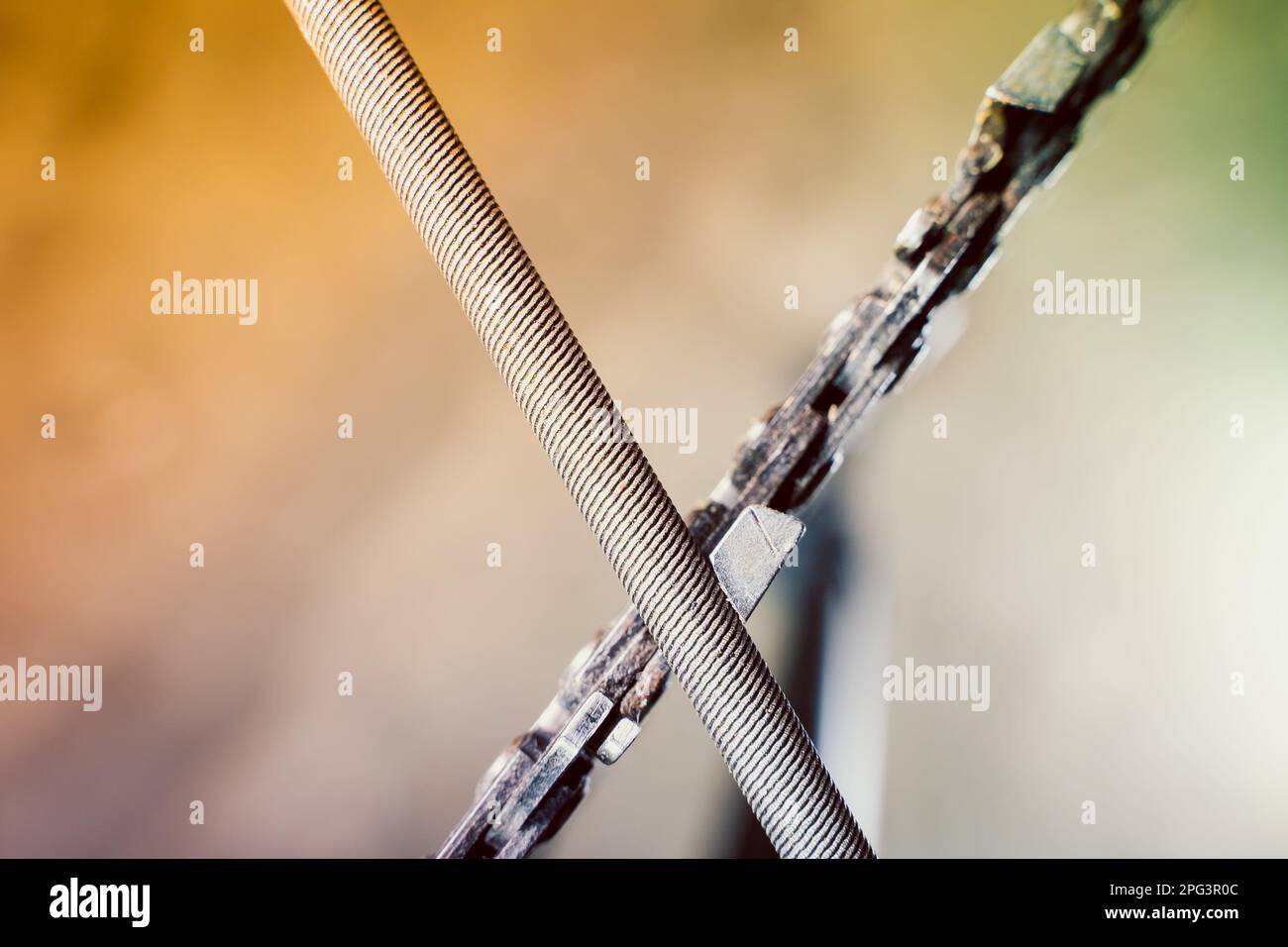 A round file sharpens a saw chain on a chainsaw bar close-up on a ...