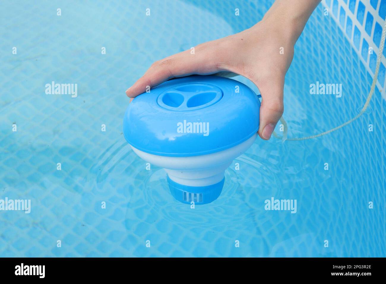 Worker hands isinfection and chlorination of water in the pool ...