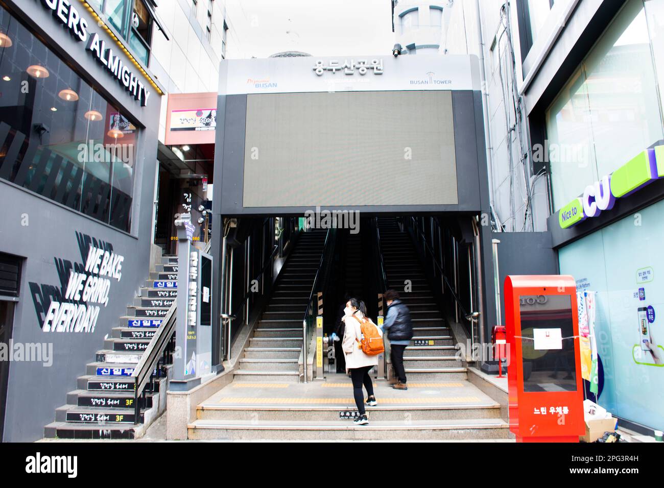 Korean people and foreign travelers walking use stairs and escalators ...