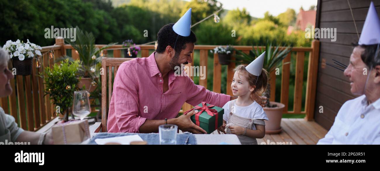 Multi generation family celebrating birthday and have garden party ...