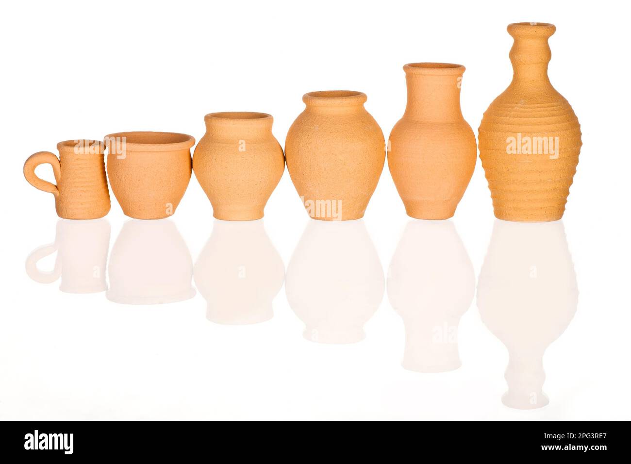 Group of old yellow crocks on isolated background Stock Photo - Alamy