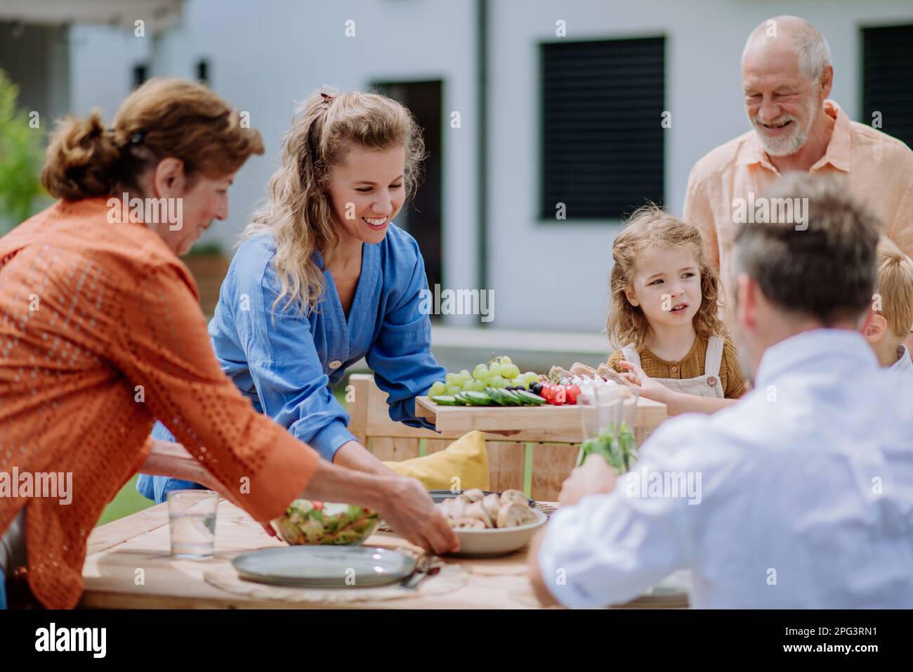 Multi generation family having outdoor garden party Stock Photo - Alamy